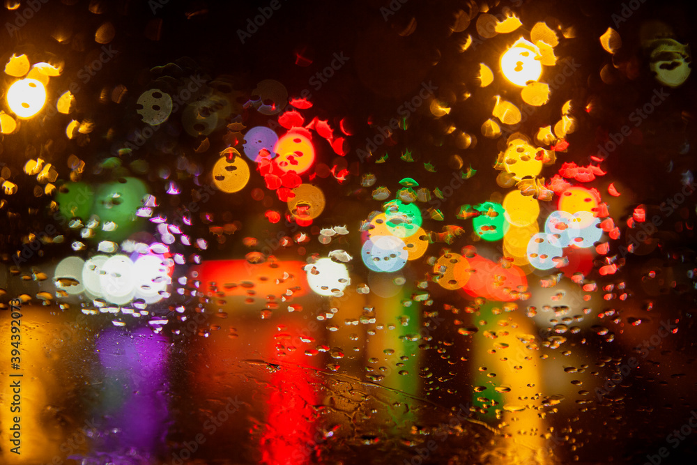 Rainy weather, night city, raindrops through the glass, abstract ...