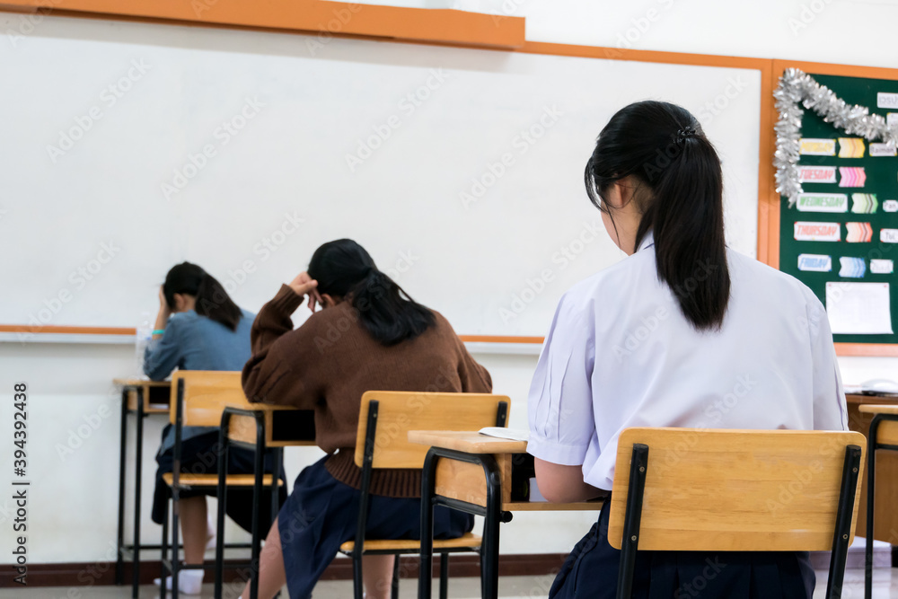 Writing test in exam with behind girl Asian students group concentrate ...