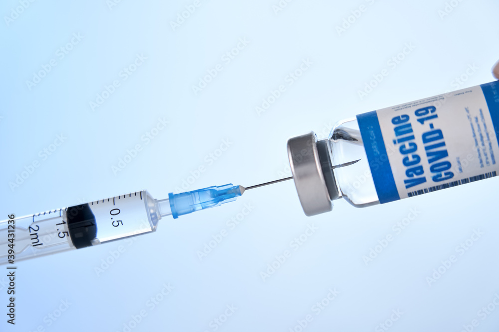 Syringe taking covid 19 corona virus liquid vaccine dose from vial ...