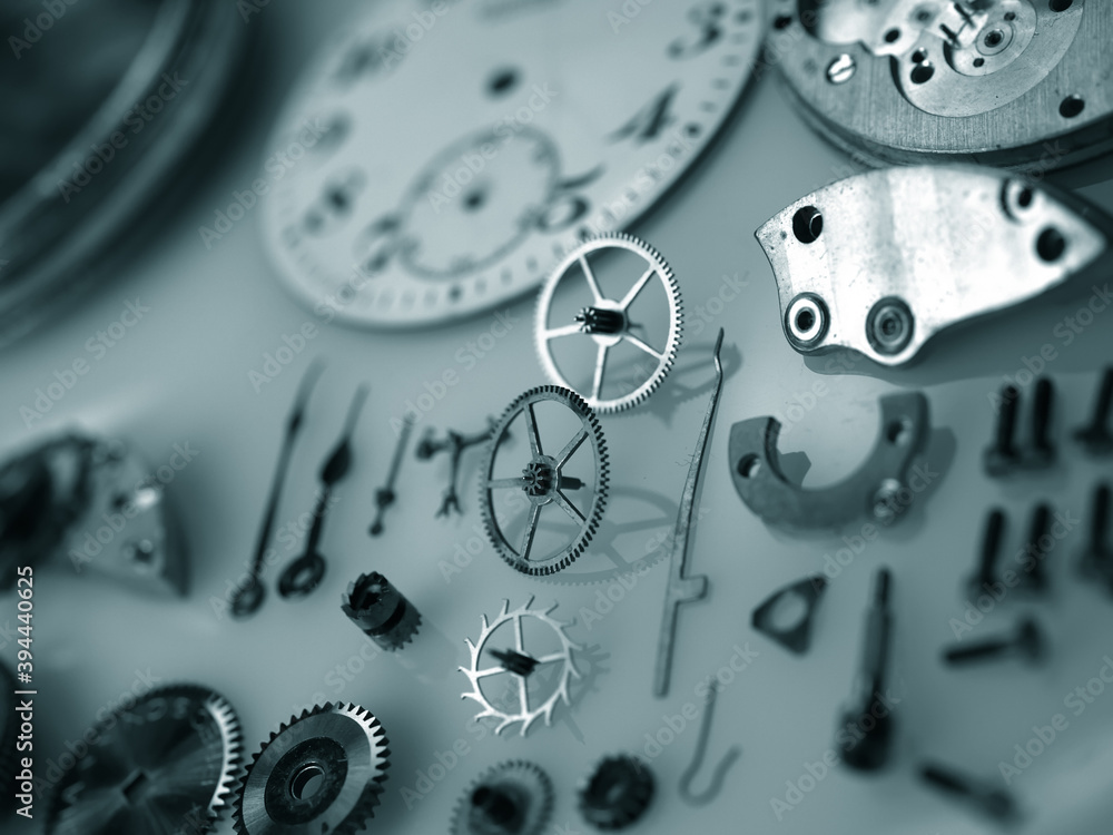 display of parts of vintage watch mechanism: dial, gears, screws ...