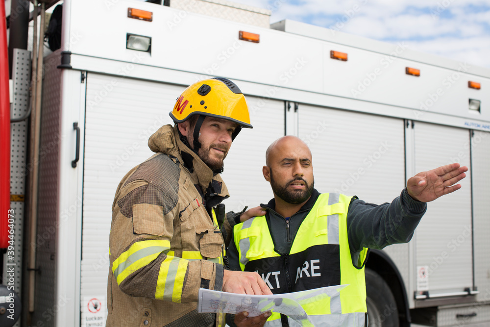 Security guard and firefighters discussing plan, Sweden Stock Photo ...