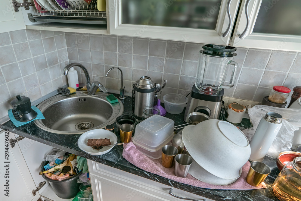 Kitchen mess. Kitchenware, pile of dirty untidy utensils in sink ...