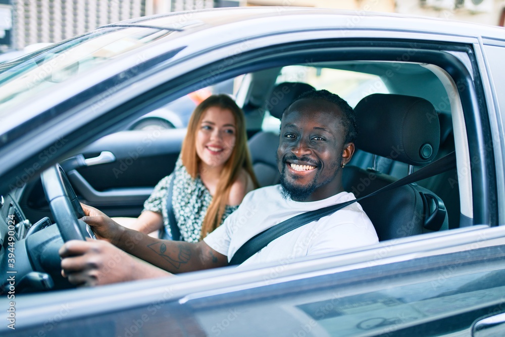 Young interracial couple smiling happy at the car. Stock Photo | Adobe ...