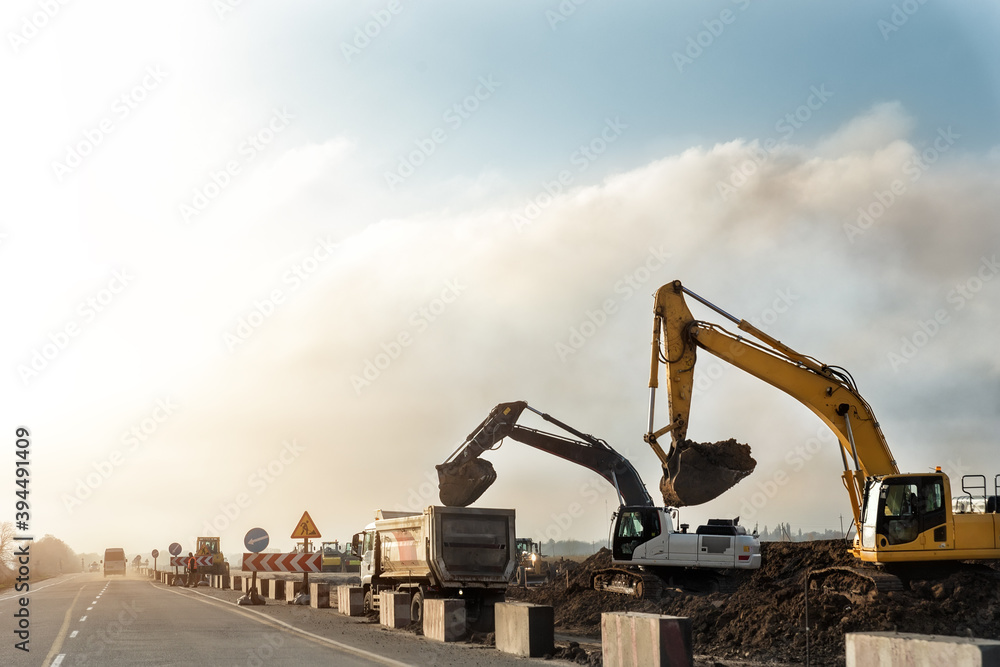 Many heavy heavy industrial road construction machinery on new highway ...