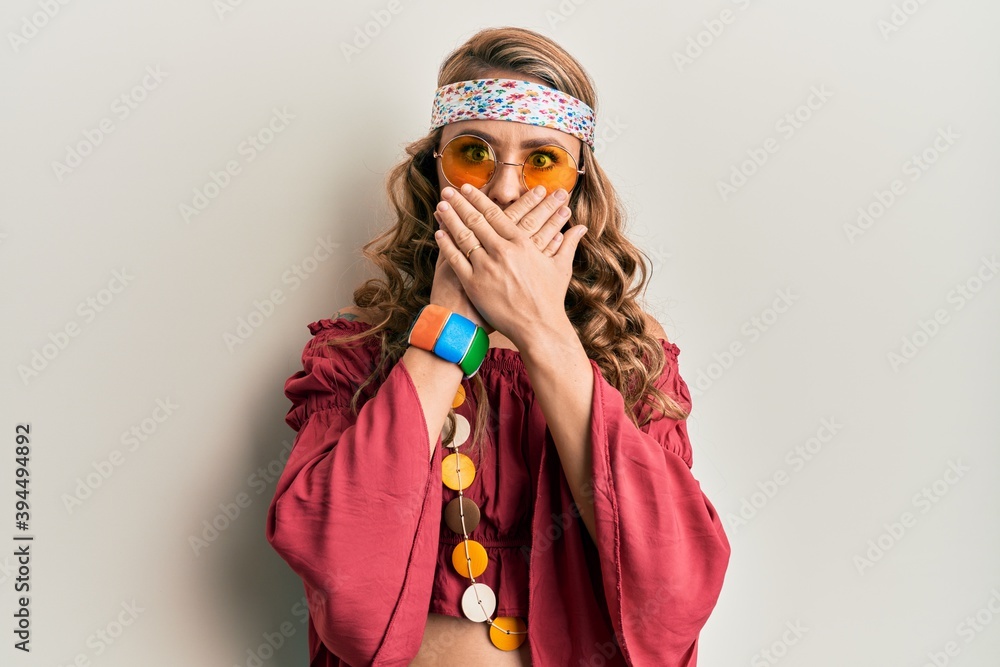 Young blonde girl wearing bohemian and hippie style shocked covering ...