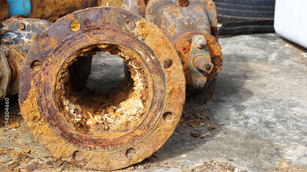 Clogged metal pipes. Suspended solids in water contaminated with iron ...