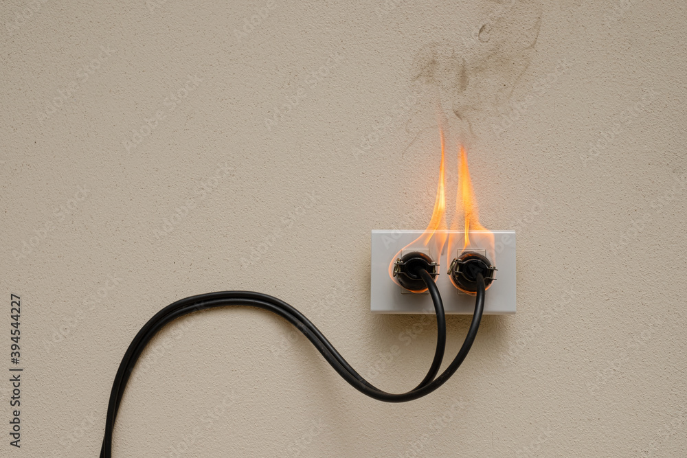 On fire electric wire plug Receptacle on the concrete wall exposed ...