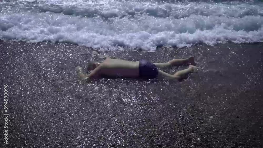 The body of a man washed up on the beach. A drowned man in swimming ...