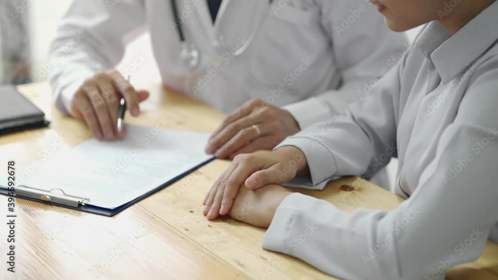 Doctor reassuring trust to patient by holding hand at hospital. Stock ...