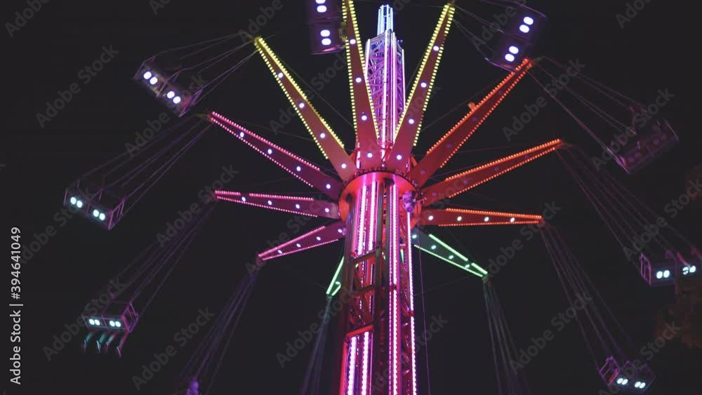 4K multicoloured tall Carousel with double seats rotating on long ...