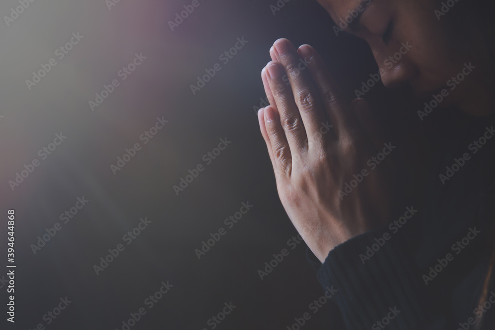 Praying hands with faith in religion and belief in God on dark ...