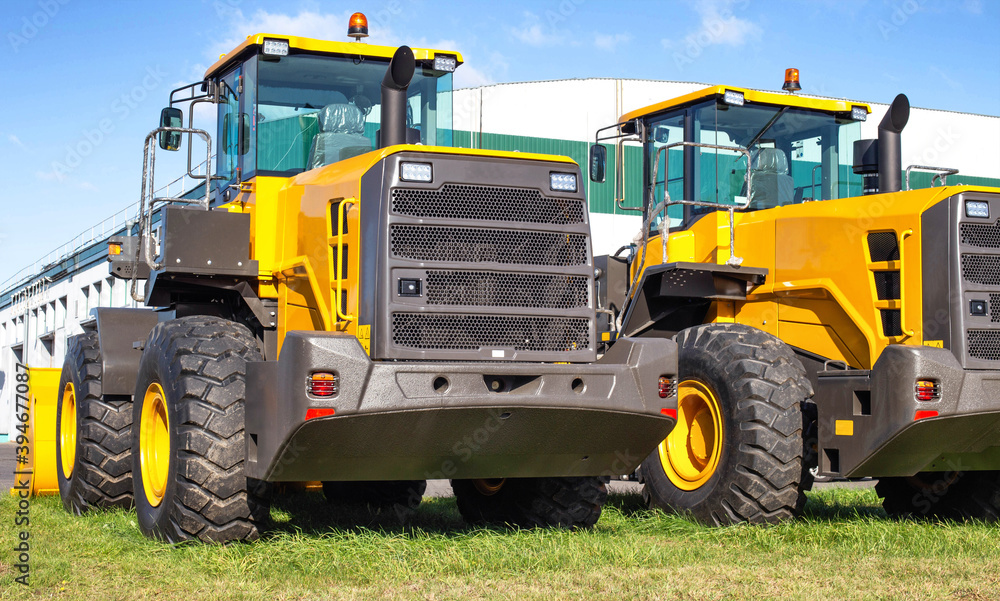 New and modern front loaders with large bucket and tipping cylinder ...