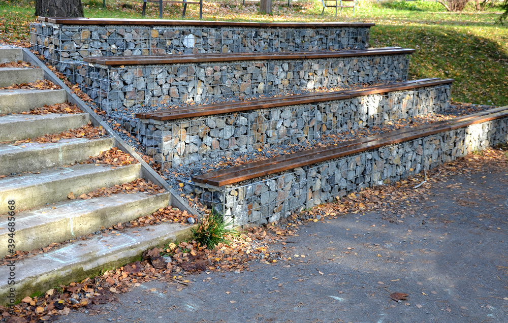 grandstand in the park by a concrete staircase made of gabion baskets ...