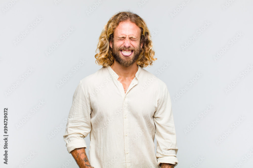 blonde man looking goofy and funny with a silly cross-eyed expression ...