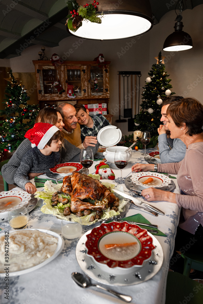 Charming caucasian extended family sitting at Christmas table. Happy ...