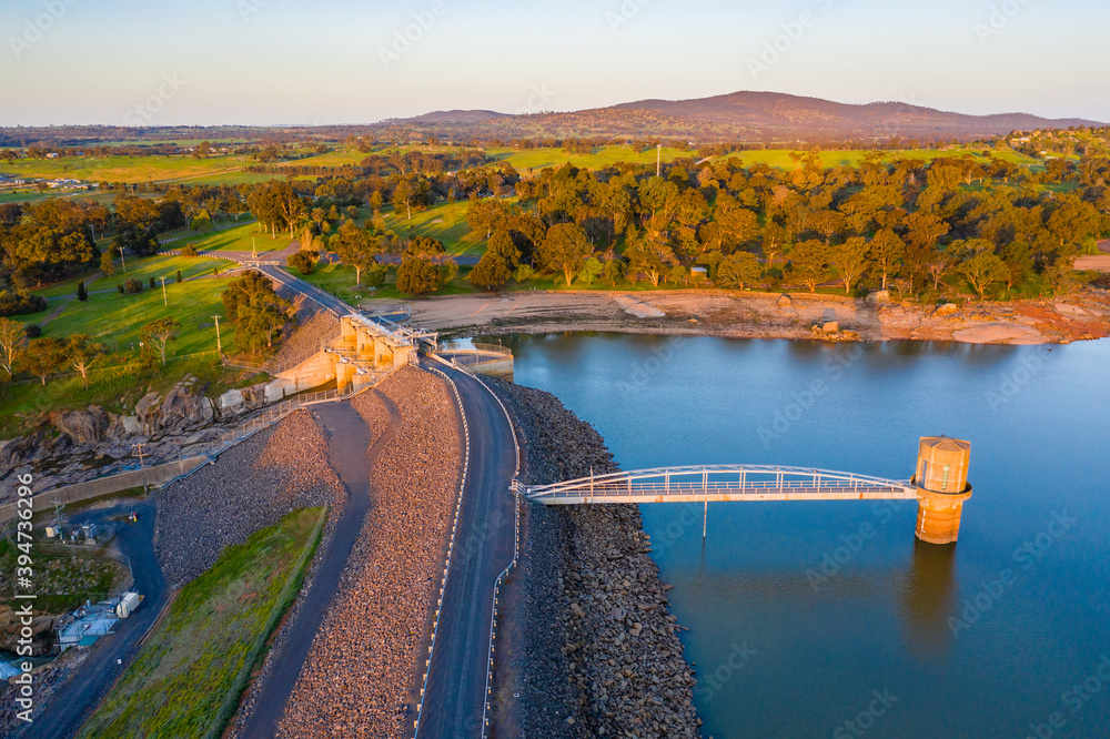Aerial view of a water tower in a reservoir connected to the dam wall ...