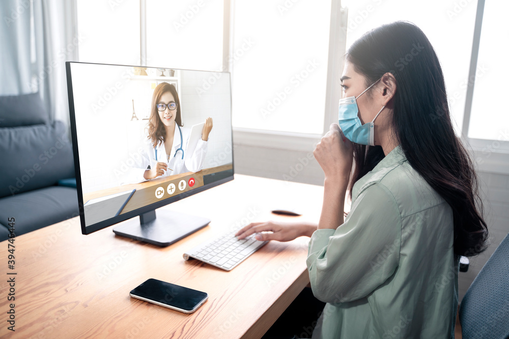 Asian woman patient in an online video call with a professional doctor ...