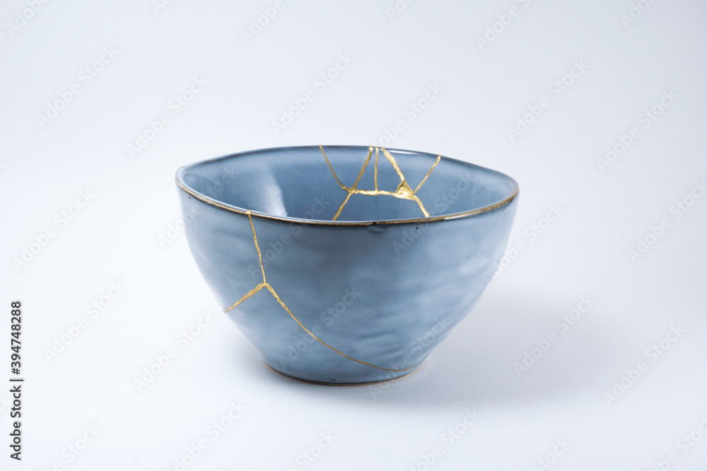 Blue kintsugi bowl. Gold cracks restoration on pottery restored with ...