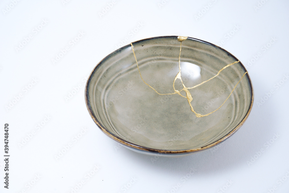 Beige kintsugi bowl. Gold cracks restoration on pottery restored with ...