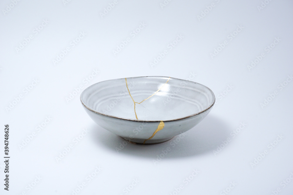 Kintsugi Japanese grey bowl. Gold cracks restoration on pottery ...