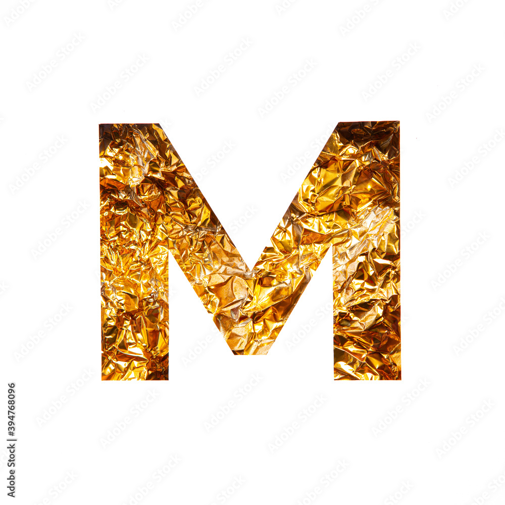 Gilded letter M of English alphabet of glittering crumpled foil and ...
