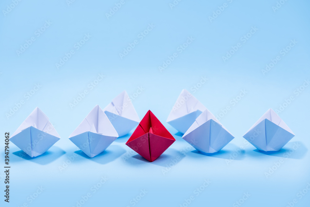 Red and white paper boats. Concept of leadership boats for teamwork ...
