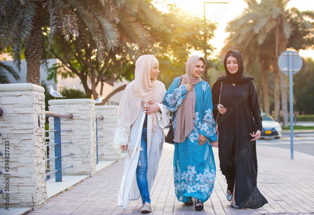 Three women friends going out in Dubai. Girls wearing the united arab ...