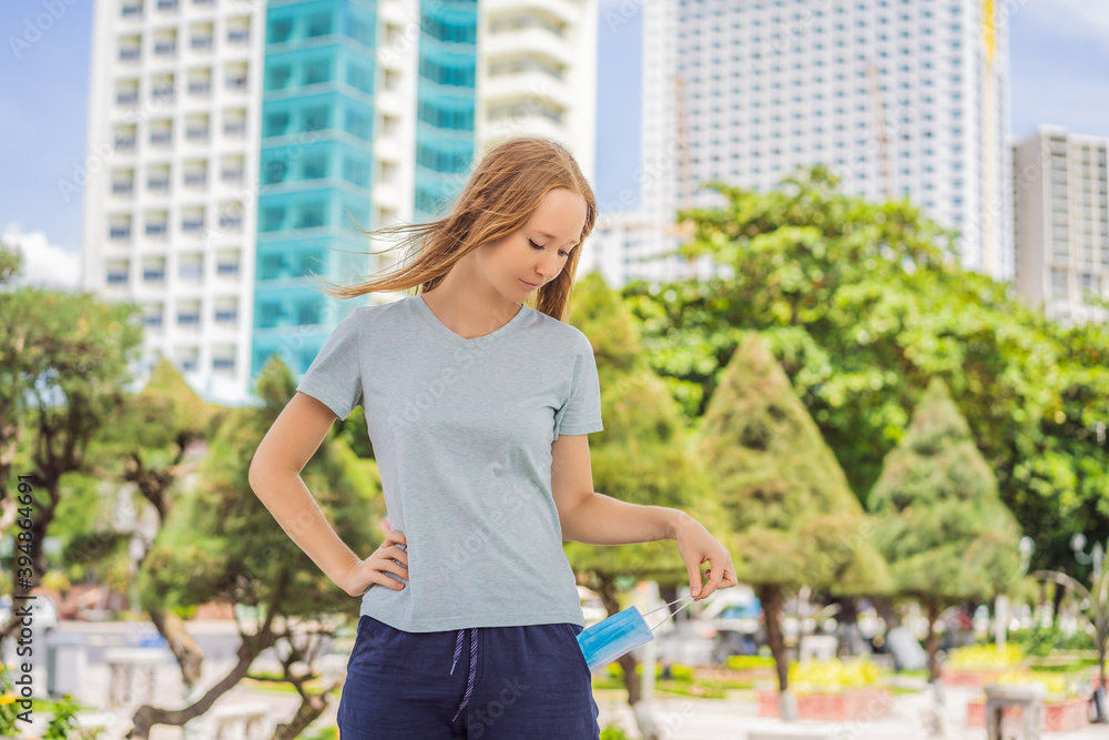 Improper wearing of mask concept. Woman wants to wear an old, crumpled ...