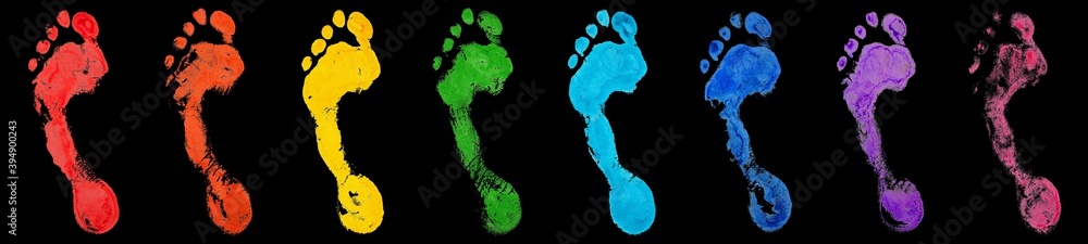 Rainbow color human footprints set black background isolated close up ...