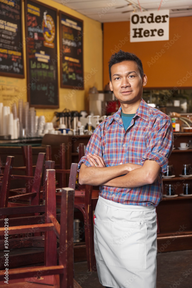 Malaysian cafe owner standing with arms crossed Stock Photo | Adobe Stock