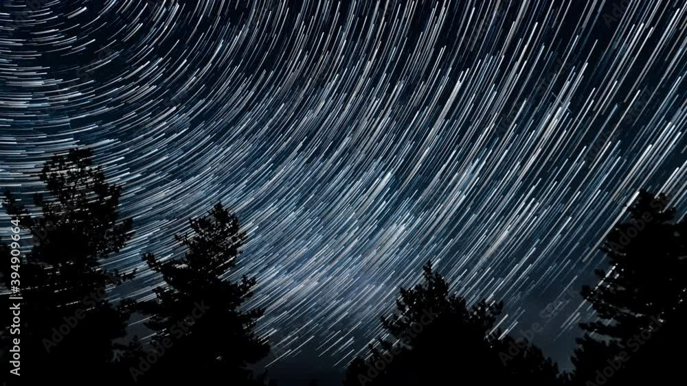 Time lapse of comet-shaped star trails in the night sky. Stars move ...