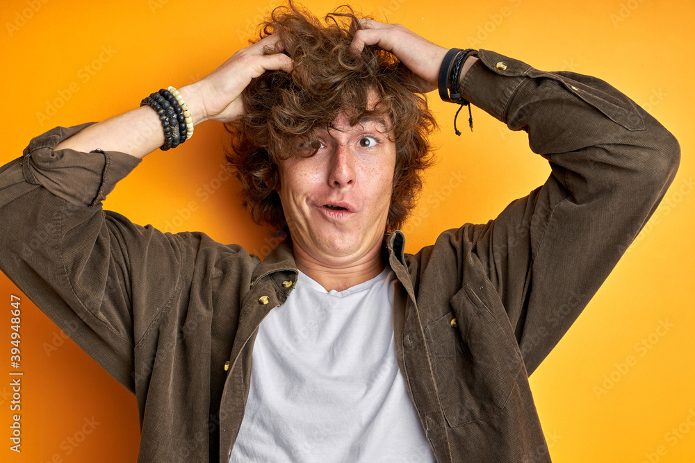 disheveled male standing like shell-shocked touching hair, in shock ...