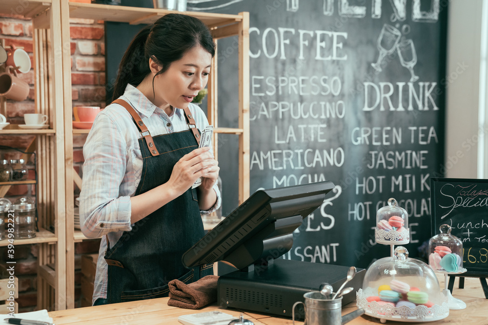 Foto de young asian japanese woman staff counting cash money at counter ...