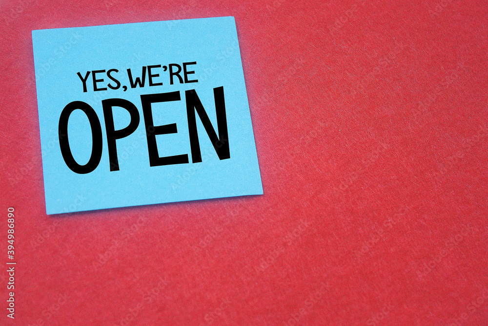 note paper written yes...we're open over red background Stock Photo ...