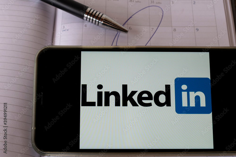 mobile phone with the Linkedin logo, on a calendar with a date marked ...
