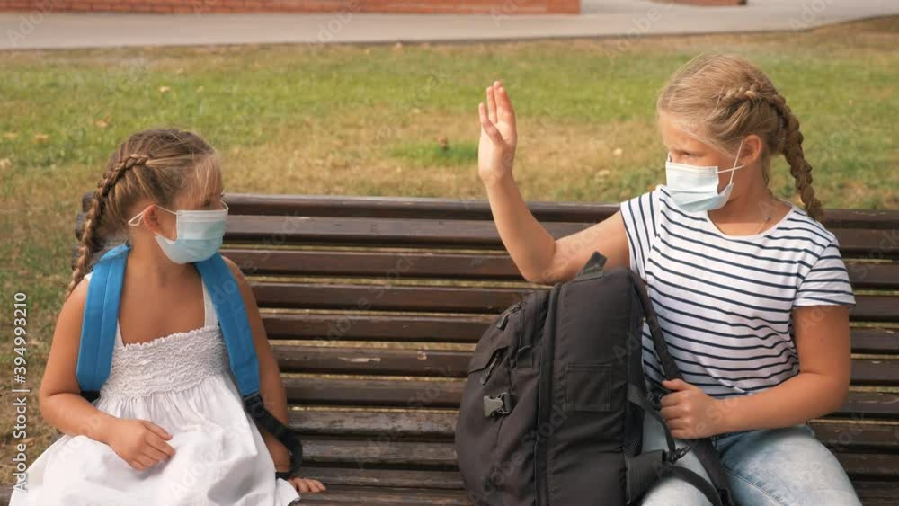 Girls in the park near the school wearing a mask. Social distance ...