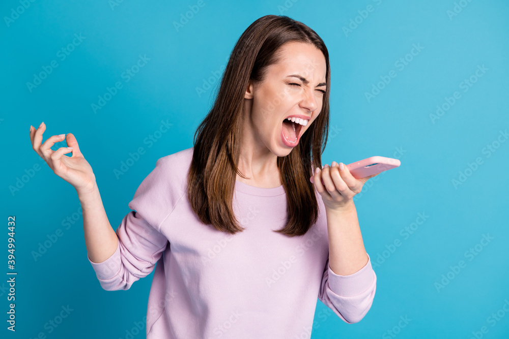 Photo of cute outraged crazy young model girl hold telephone provoked ...