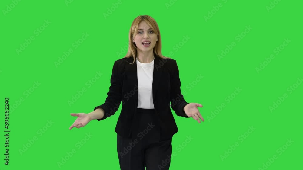 Beautiful young woman in formal outfit walking and talking to camera on ...