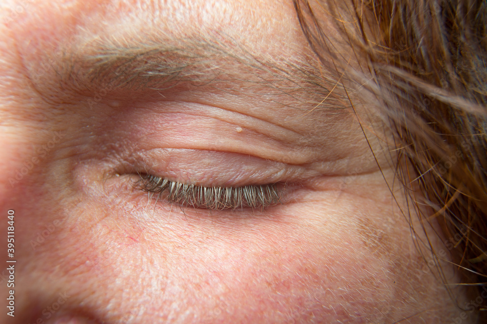 Detail of an closed eye of a woman. Front view. Details of a male face ...