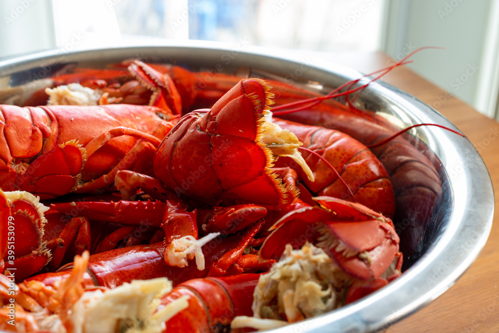 Foto de A large aluminum bowl of cooked lobster on a table in a ...