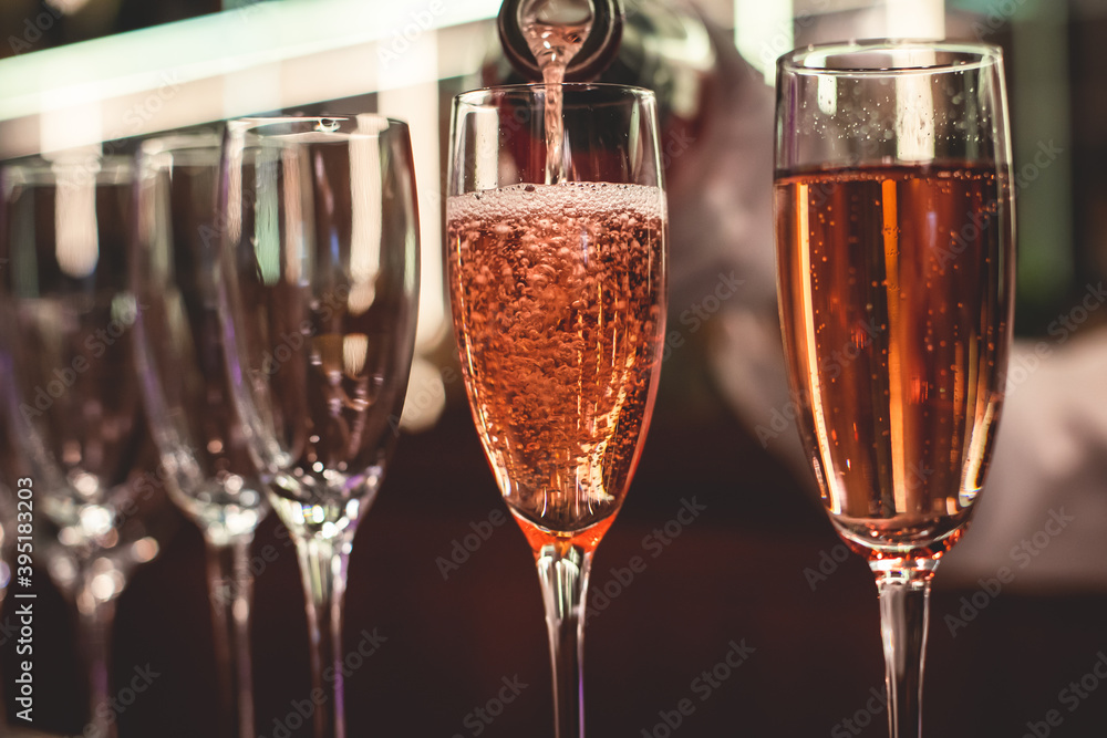 Line of alcohol setting on catering banquet table, bartender pouring ...