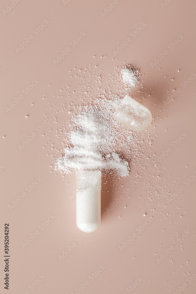 Health care concept. White medical open capsule with powder inside on ...