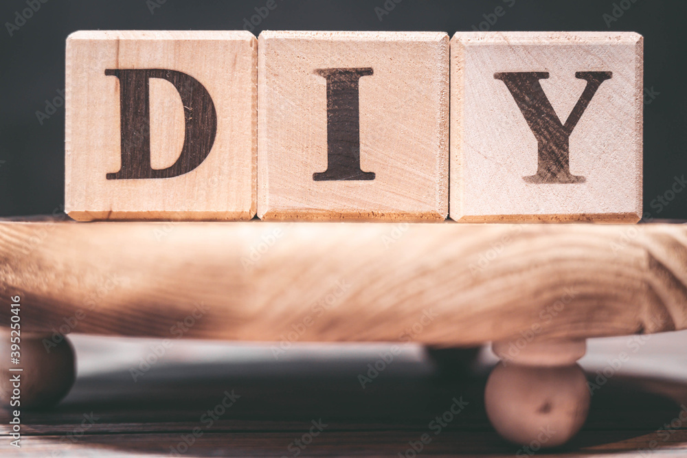 Text DIY on wood cube blocks. The letters DIY written on the cubes in ...