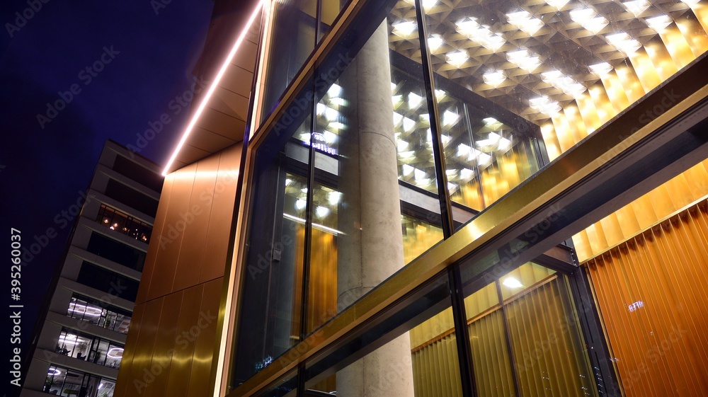 Pattern of office buildings windows illuminated at night. Lighting with ...