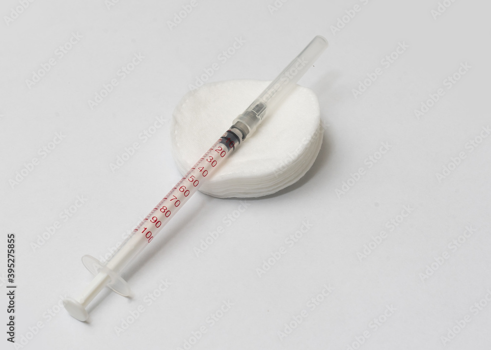 Medical treatment vaccine and syringe for injections on a white ...