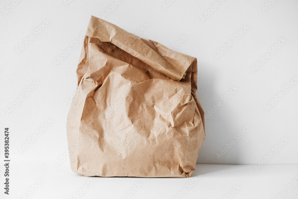 Full crumpled disposable bag of brown kraft paper on a white background ...