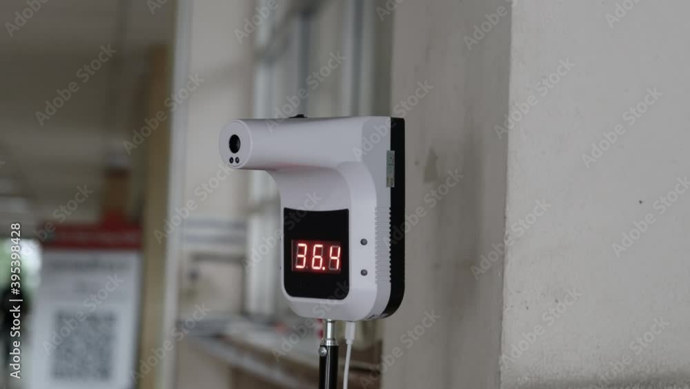 Young man used his palm to touch the sensor of the thermometer ...