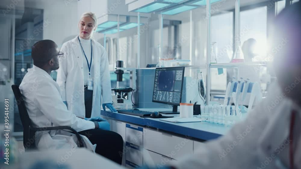 Modern Medical Research Laboratory: Two Scientists Use Computer with ...
