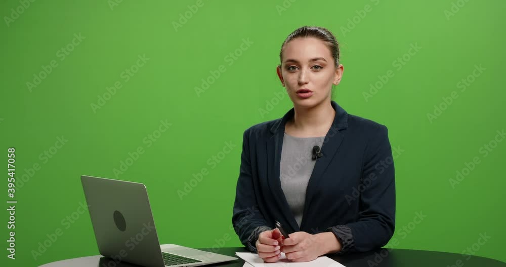 Professional female news anchor talking during live broadcast ...