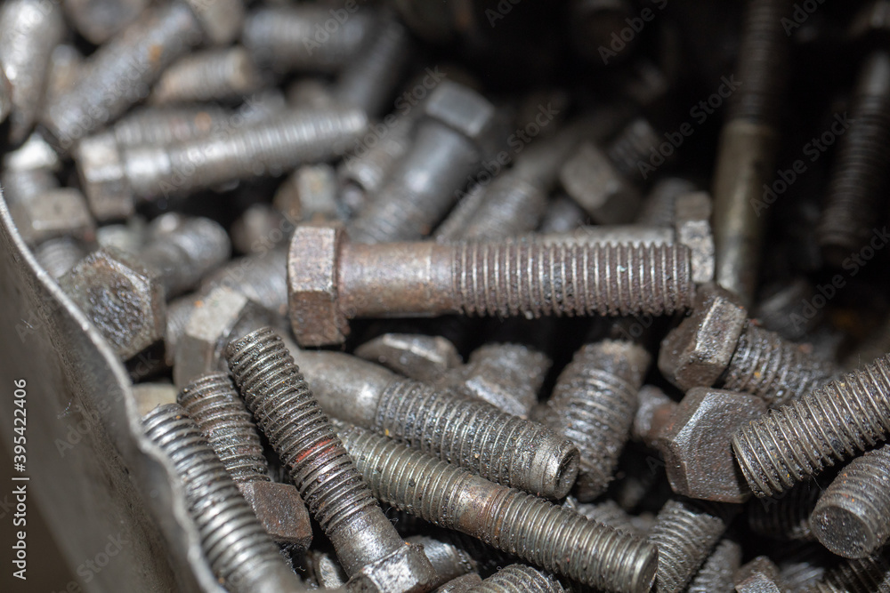 Piles of many bolts and screws are dirty and rusty texture background ...